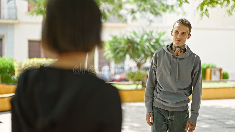 Beautiful Couple Standing Together with Serious Face at Park Stock ...