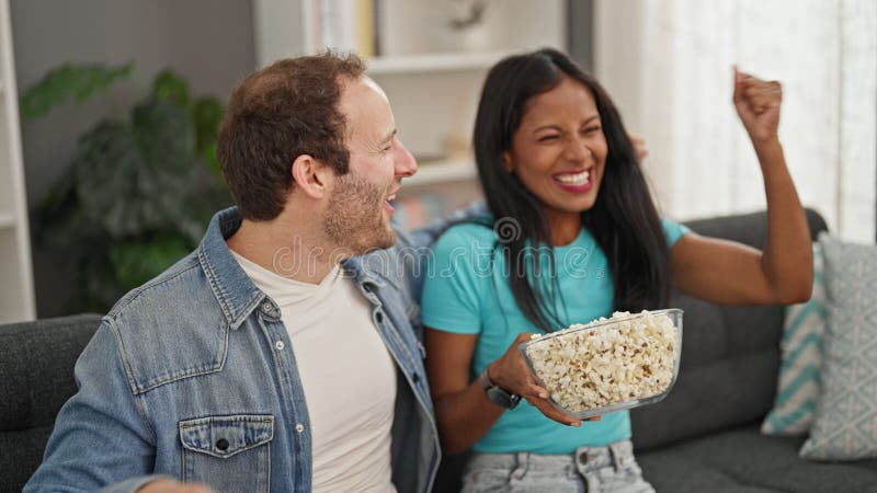 Beautiful Couple Watching Tv Eating Popcorn High Five at Home Stock ...