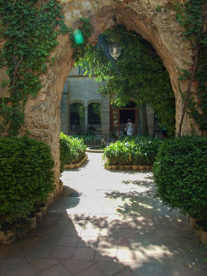 Beautiful Courtyard Under a Stone Archway Stock Image - Image of ...