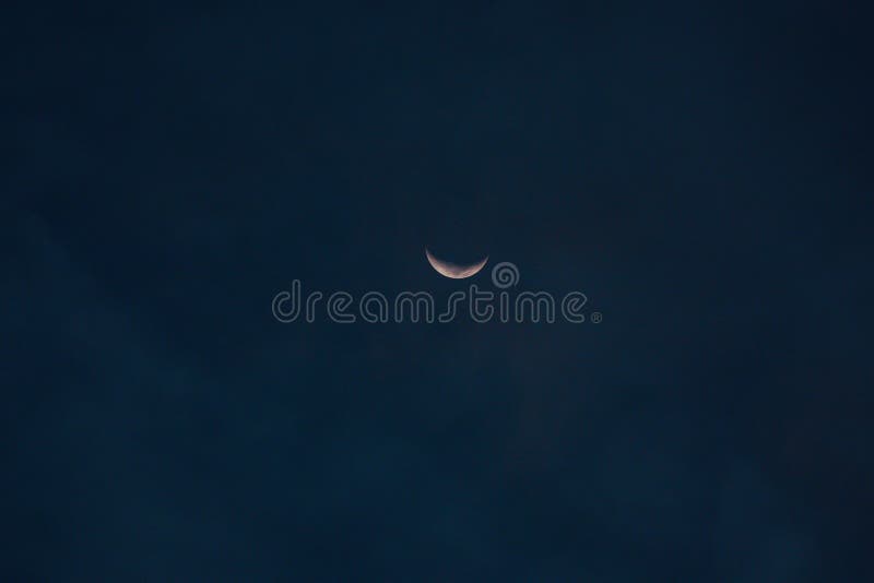 Beautiful Crescent Moon Barely Visible in a Blue Night Sky Stock Photo ...