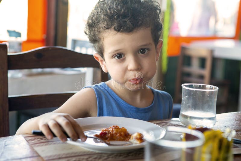 Curly-haired Caucasian Boy Eating in Restaurant Stock Image - Image of ...