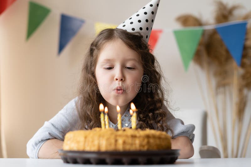 A Beautiful Cute Girl Has A Birthday She Blows Out The Candles On The