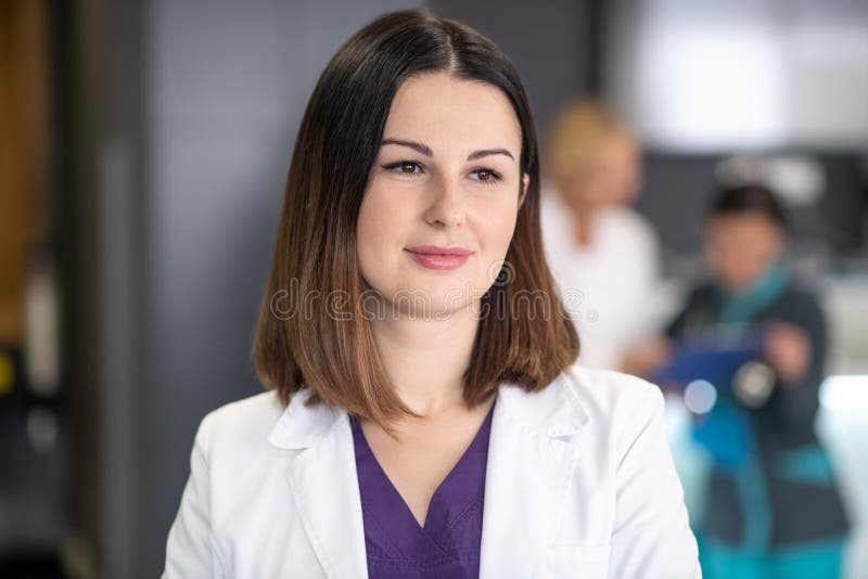 Beautiful Dark-haired Doctor in White Robe Looking Thoughtful Stock ...