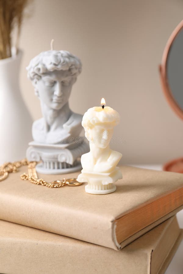 Beautiful David Bust Candles and Books on Table Stock Image - Image of ...