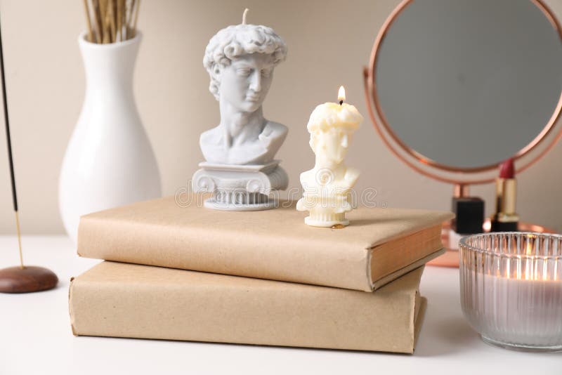 Beautiful David Bust Candles and Books on White Dressing Table Stock ...