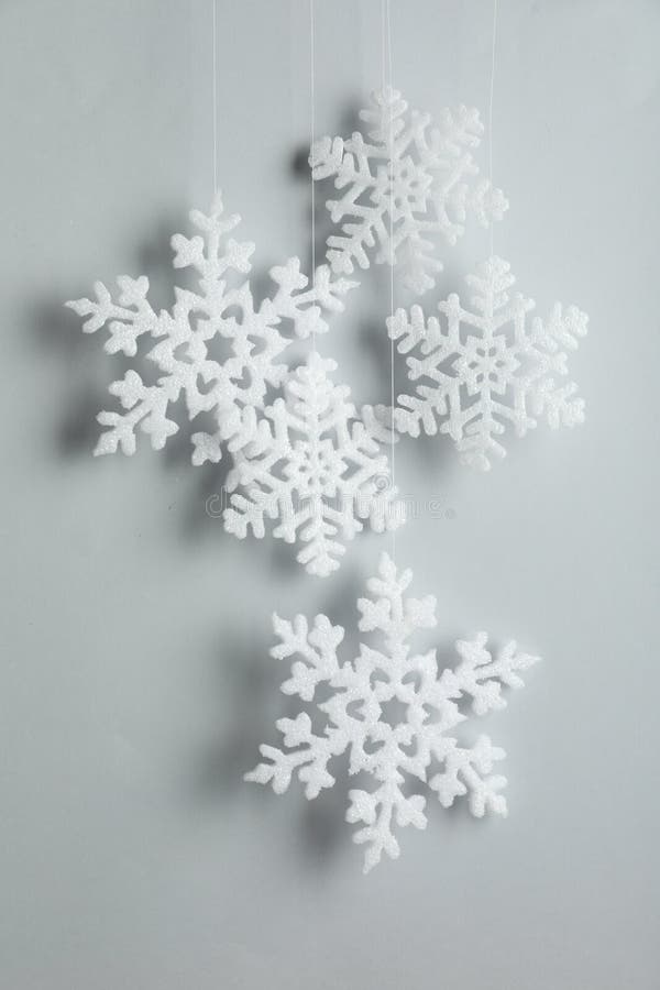 Beautiful Decorative Snowflakes Hanging on Light Grey Background Stock ...