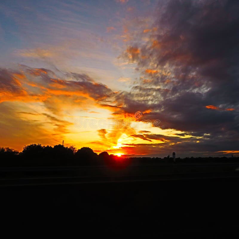 Beautiful Display of a Burning Bright Sunset in a Cloudy Sky and a ...