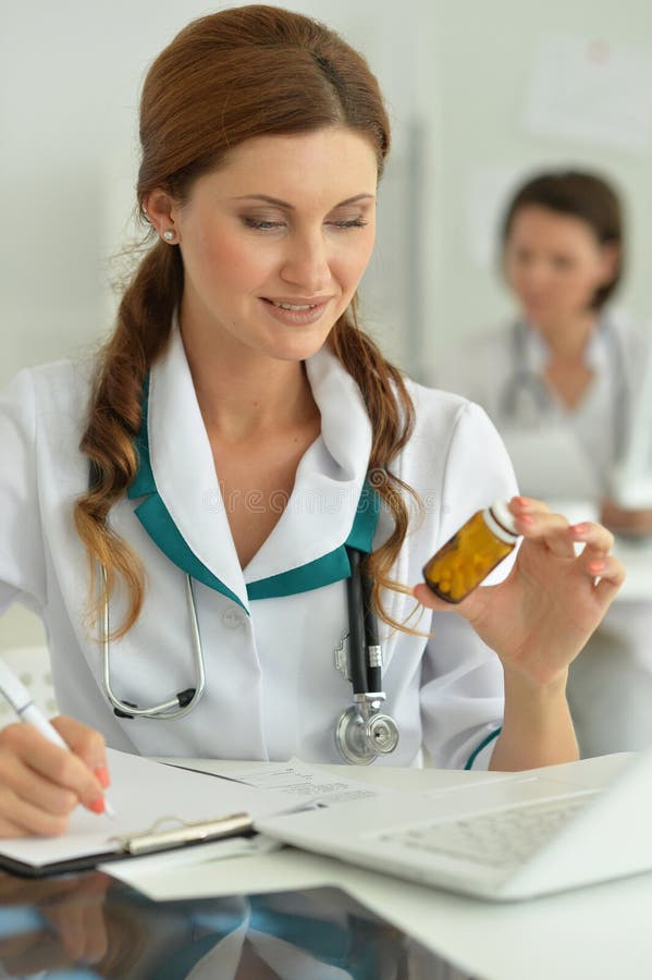 Doctor Sitting at Desk at Work in Hospital Stock Image - Image of ...