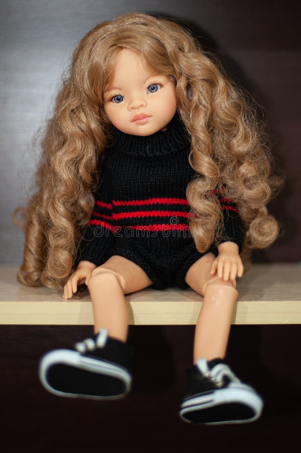 Beautiful Doll Sits with Her Head Tilted To the Side. Stock Photo ...