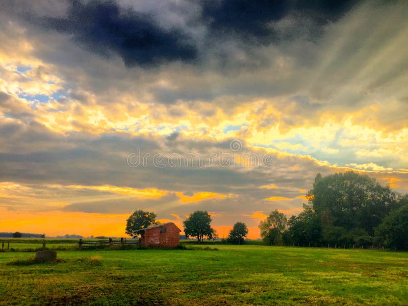 Beautiful Dramatic Sunset Over a Field Stock Image - Image of beauty ...