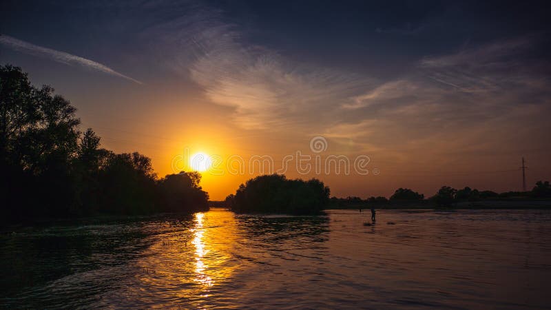 Beautiful Dramatic Sunset on River with Silhouettes of Trees in Shadows ...