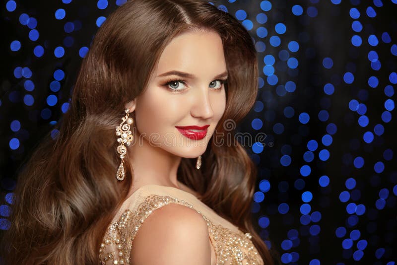 Beautiful Elegant Model Brunette With Long Wavy Hair And Jewelry Stock