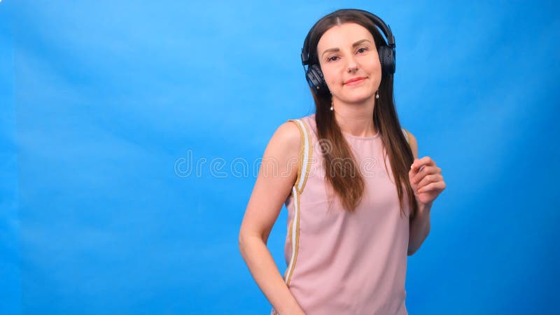 Beautiful Energy Girl With Headphones Listening To Music On A Blue