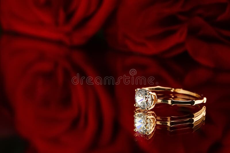 Beautiful Engagement Ring with Gemstone and Roses on Mirror, Closeup ...