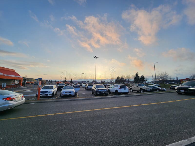 A Beautiful Evening Sunset in a Full Parking Lot Stock Image - Image of ...