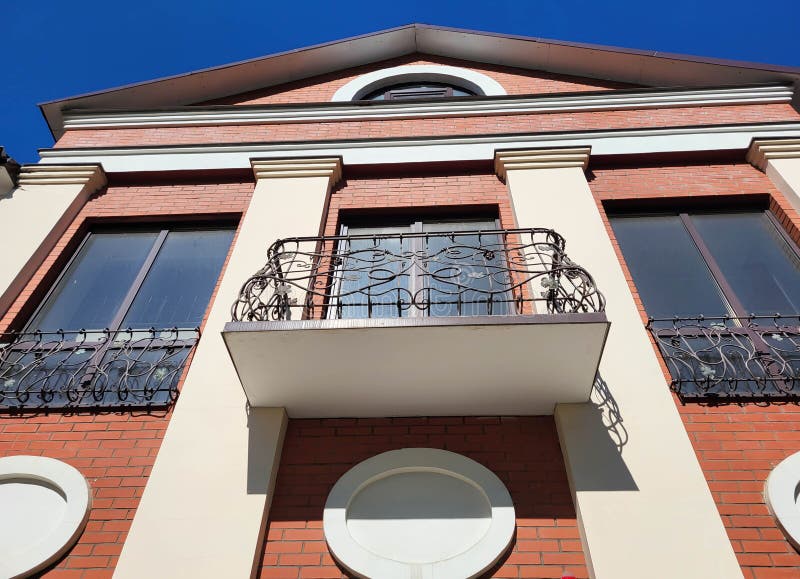 Beautiful Facade of a Two-storey House with a Wrought-iron Balcony and ...