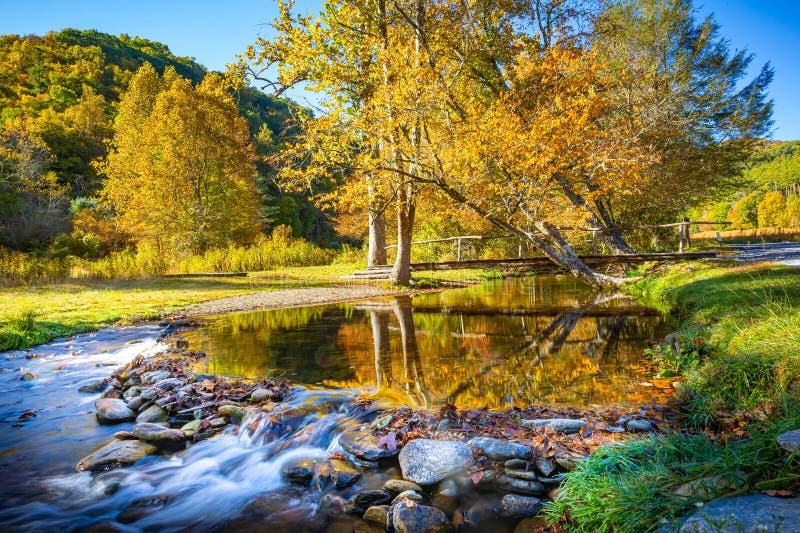 Beautiful Fall Scene with Water, a Bridge and a Small Waterfall Stock ...