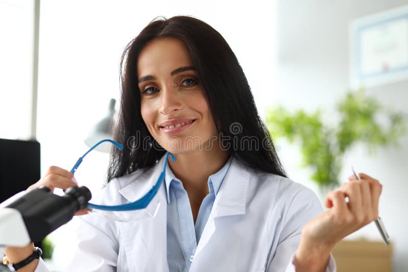Beautiful Female Assistant Sitting at Worktable Stock Photo - Image of ...