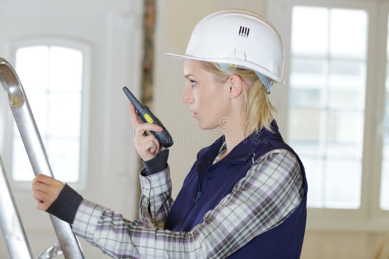Beautiful Female Builder Using Walkie Talkie Stock Photo - Image of ...