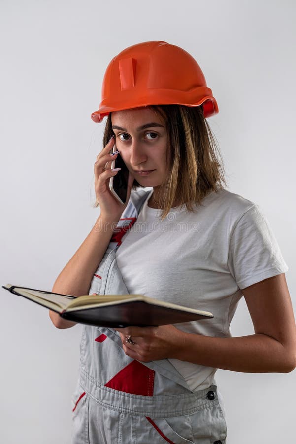 Beautiful Female Construction Worker Holding a Folder with Documents in ...