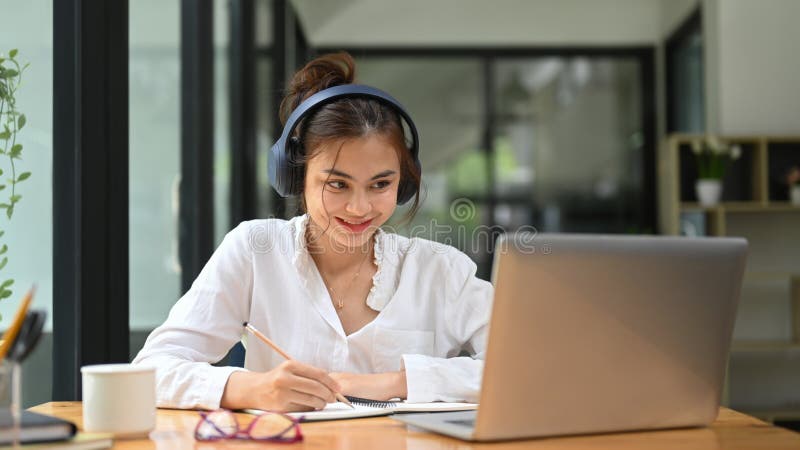 Beautiful Female Employee Using Laptop Computer at Bright Modern ...