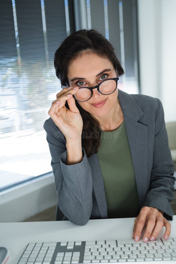 Beautiful Female Executive in Spectacles Working at Desk Stock Photo ...