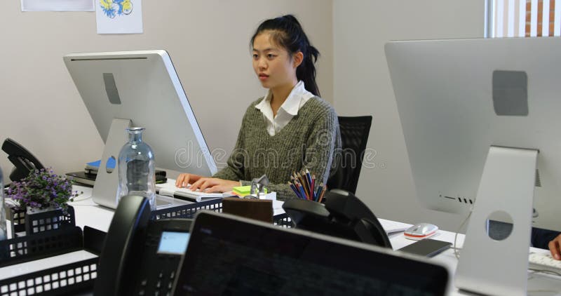 Beautiful Female Executive Working on Computer in Office Stock Photo ...