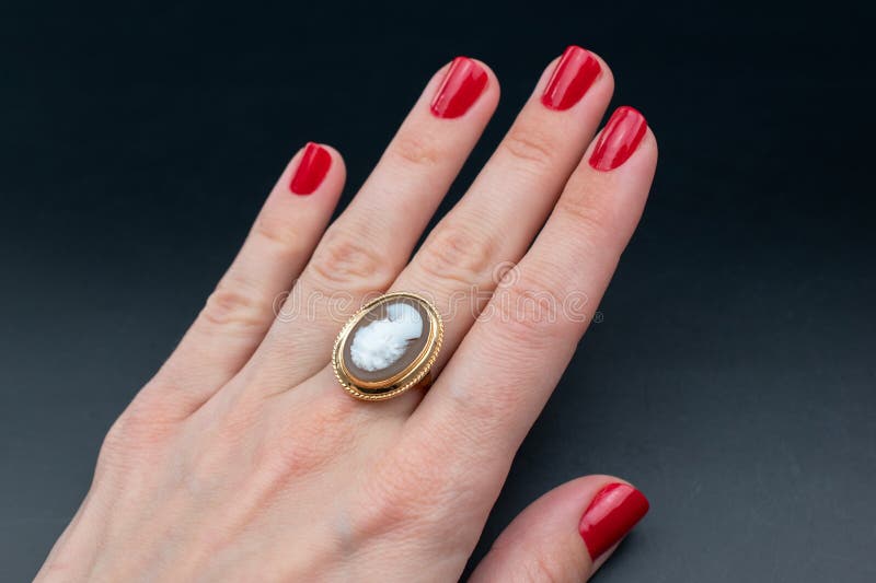 Beautiful Female Hand with Red Manicure Holding a Diamond Ring. Stock ...