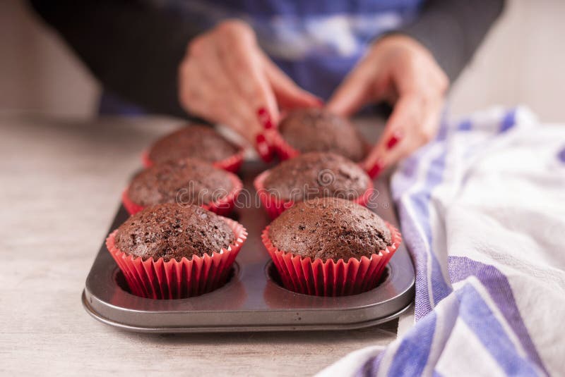 Beautiful Female Hands Take a Cupcake Out of Shape. Stock Photo - Image ...