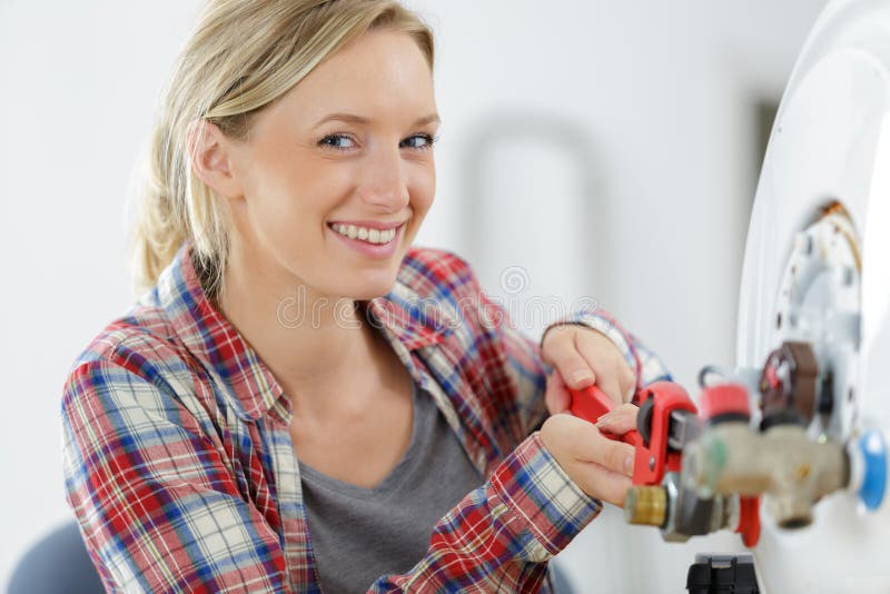 Beautiful Female Plumber Working on Central Heating Boiler Stock Photo ...