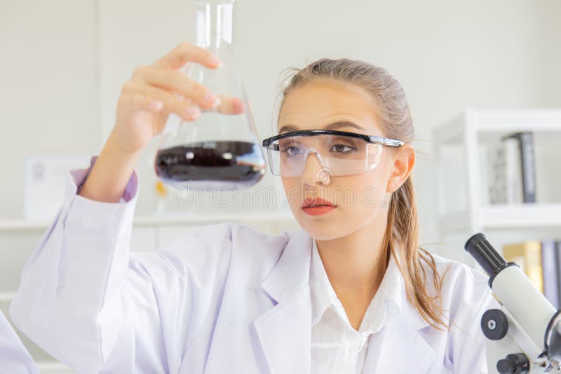 Beautiful Female Scientist is Operating in a Science Lab with Various ...