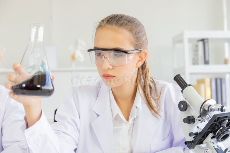 Beautiful Female Scientist is Operating in a Science Lab with Various ...