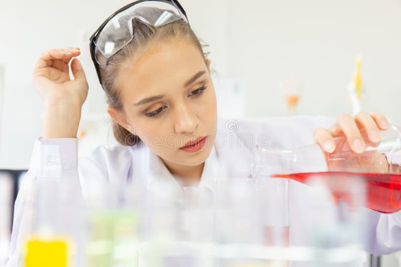 A Beautiful Female Scientist is Operating in a Science Lab with Various ...