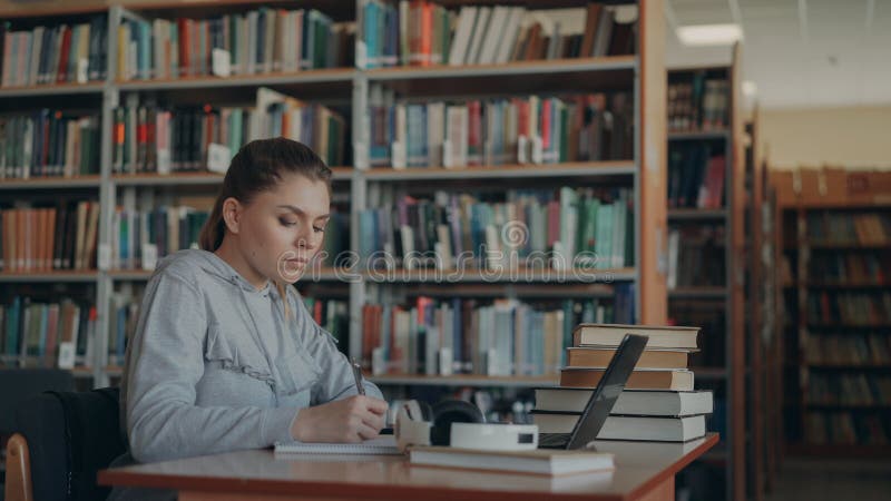 Beautiful Serious Caucasian Female Student Sitting at Table with Books ...