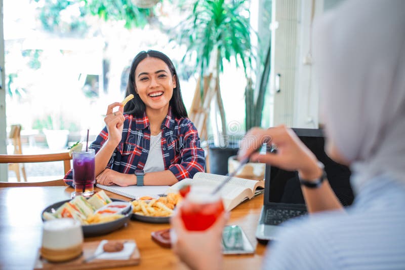 Beautiful Female University Student Eating a Snack while Doing Group ...