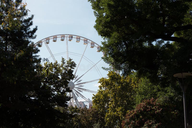 Beautiful Ferris Wheel with White Cabs on a Background of Blue Sky ...