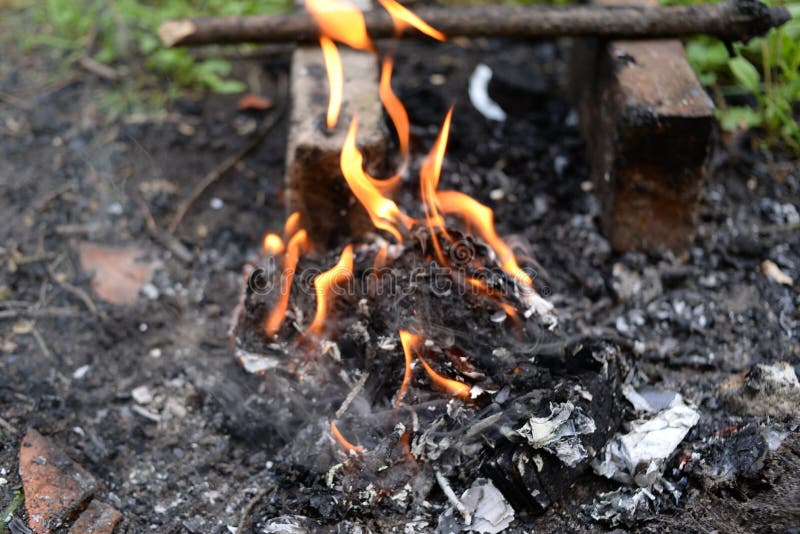 Beautiful Flame of Fire on a Green Background of Grass Stock Photo ...