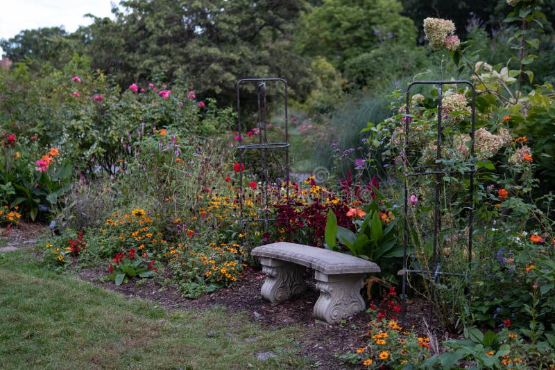 Beautiful Flower Filled Garden with a Stone Bench Stock Photo - Image ...