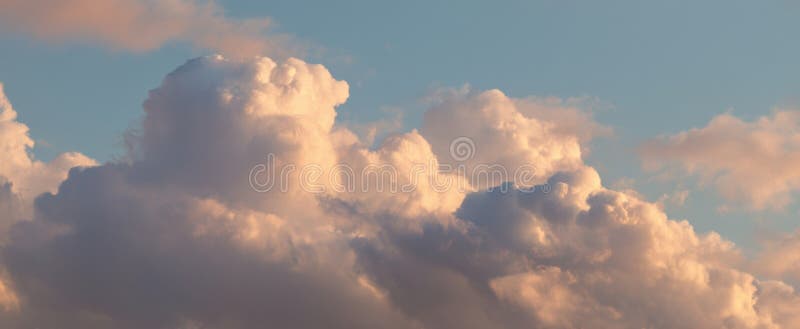 The Beautiful Fluffy Clouds Illuminated by Soft Sunset Hues in the ...