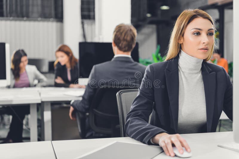 Beautiful Focused Young Businesswoman Sitting at Workplace and Stock ...