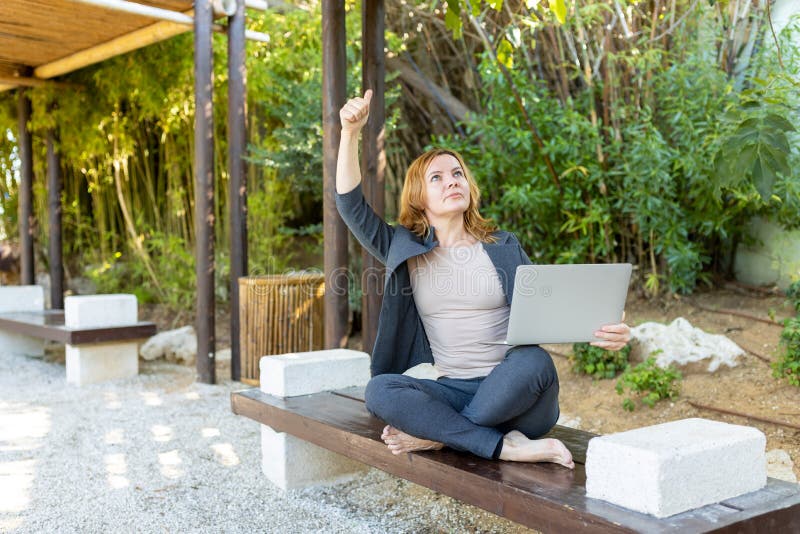 A Beautiful Freelancer Woman Works at the Park Using a Computer Stock ...