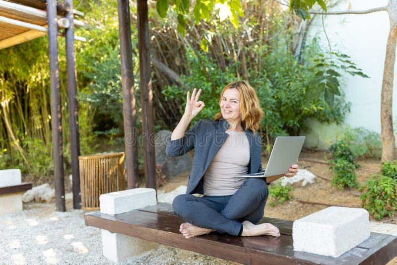 A Beautiful Freelancer Woman Works at the Park Using a Computer Stock ...