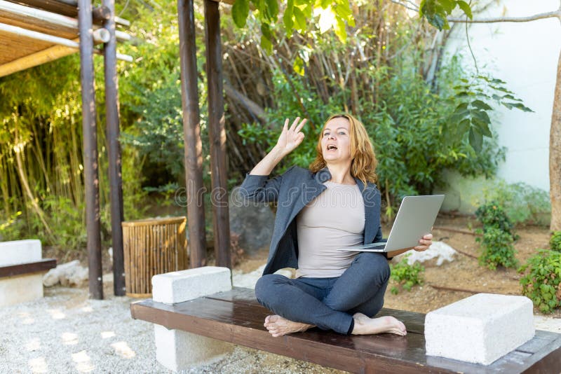 A Beautiful Freelancer Woman Works at the Park Using a Computer Stock ...