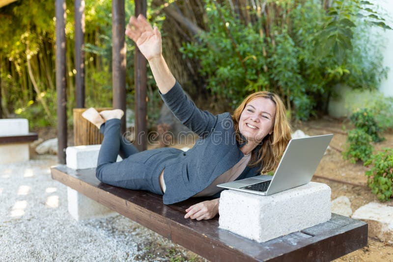 A Beautiful Freelancer Woman Works at the Park Using a Computer Stock ... A Beautiful Freelancer Woman Works at the Park Using a Computer Stock ...
