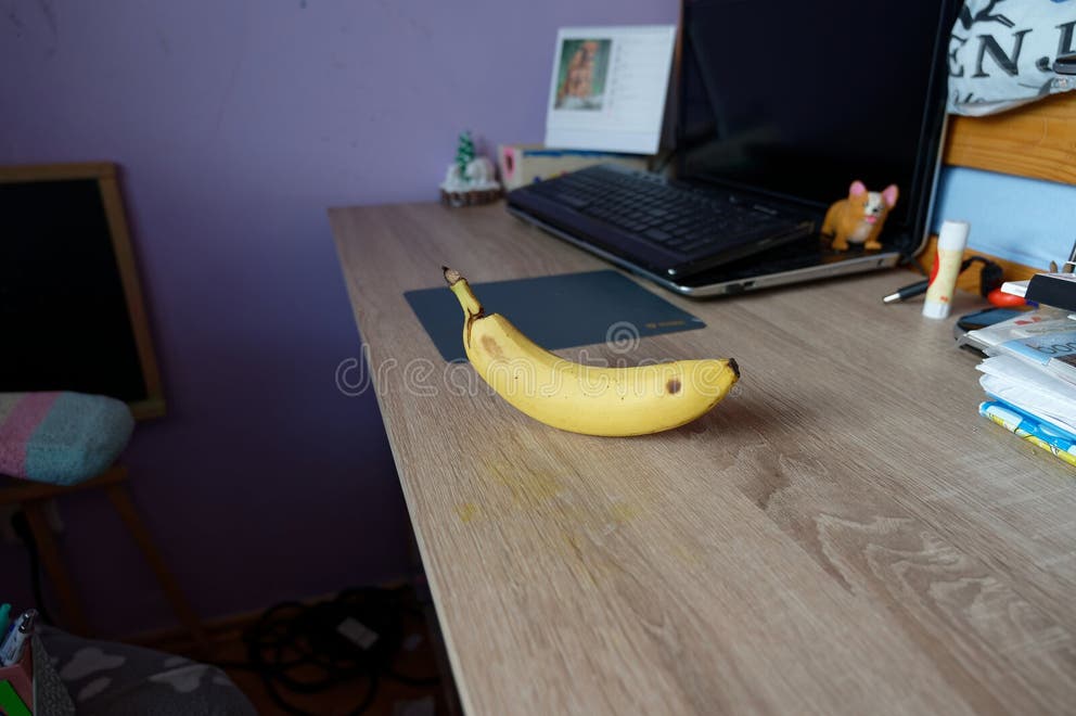 A Beautiful Fresh Banana on a Work Table at Home or in the Office with a Computer or Laptop ...
