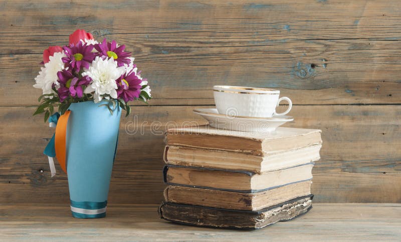 Beautiful Fresh Spring Flowers with Stack of Books on a Table Stock ...