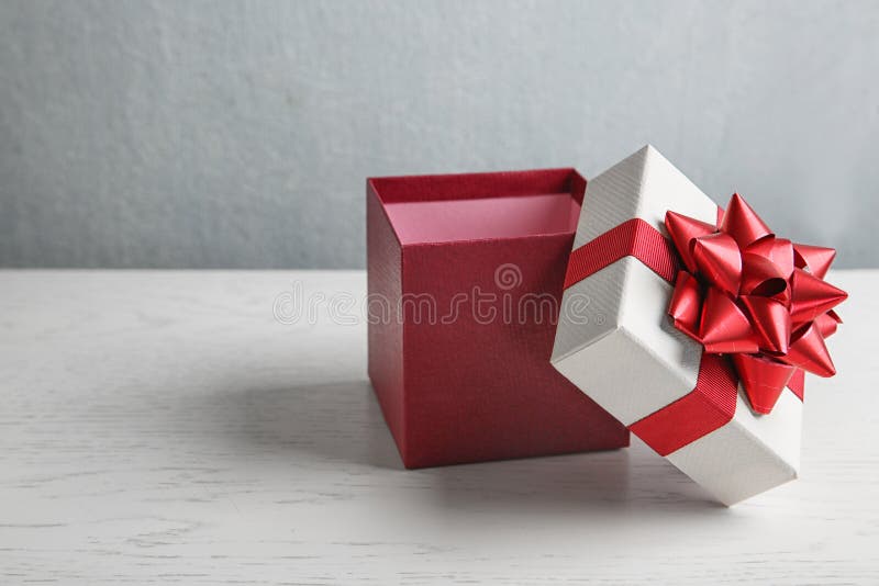 Beautiful Gift Box on White Wooden Table. Space for Stock Image - Image ...