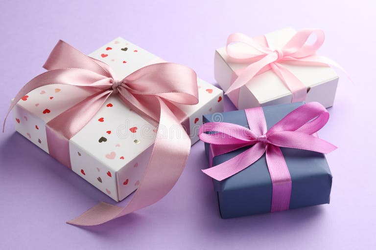 Beautiful Gift Boxes with Pink Bows on Violet Background Stock Image ...