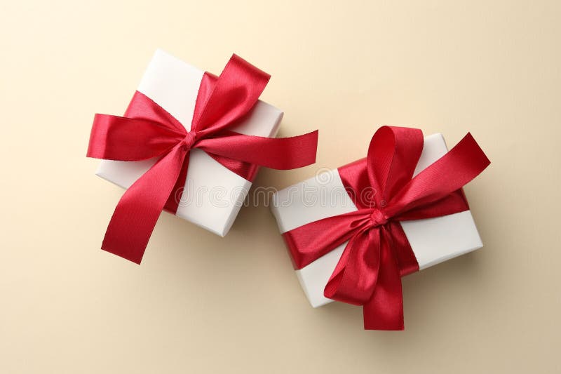 Beautiful Gift Boxes with Red Bows on Beige Background, Top View Stock ...