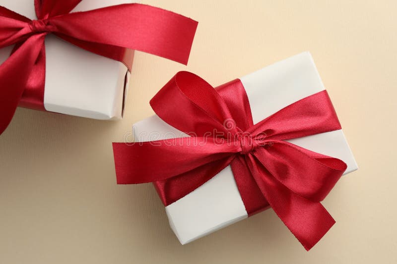 Beautiful Gift Boxes with Red Bows on Beige Background, Top View Stock ...